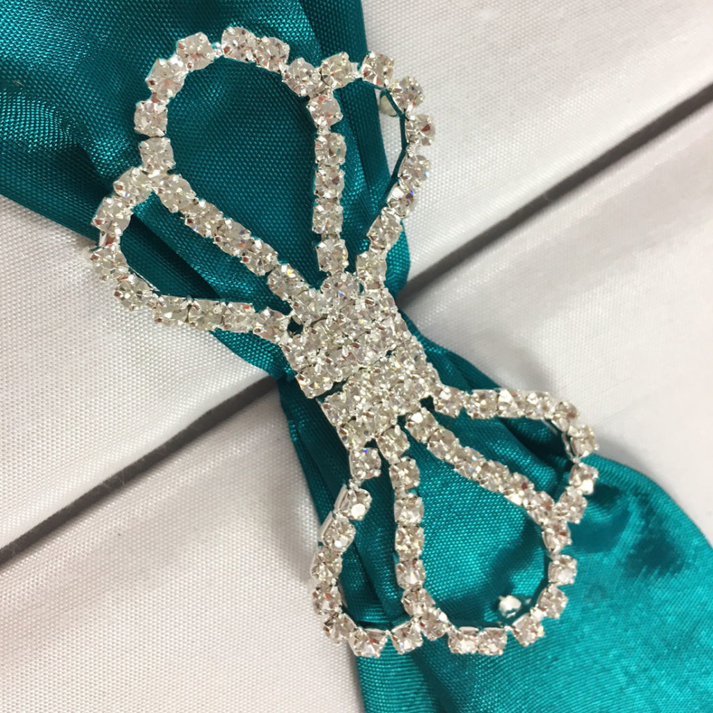 Special Event Invitation For A White Wedding Featuring Diamond Clasp